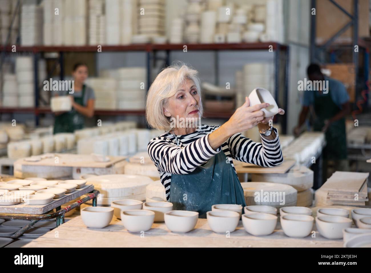 Senior woman potter with new crafted ceramic bowls Stock Photo - Alamy