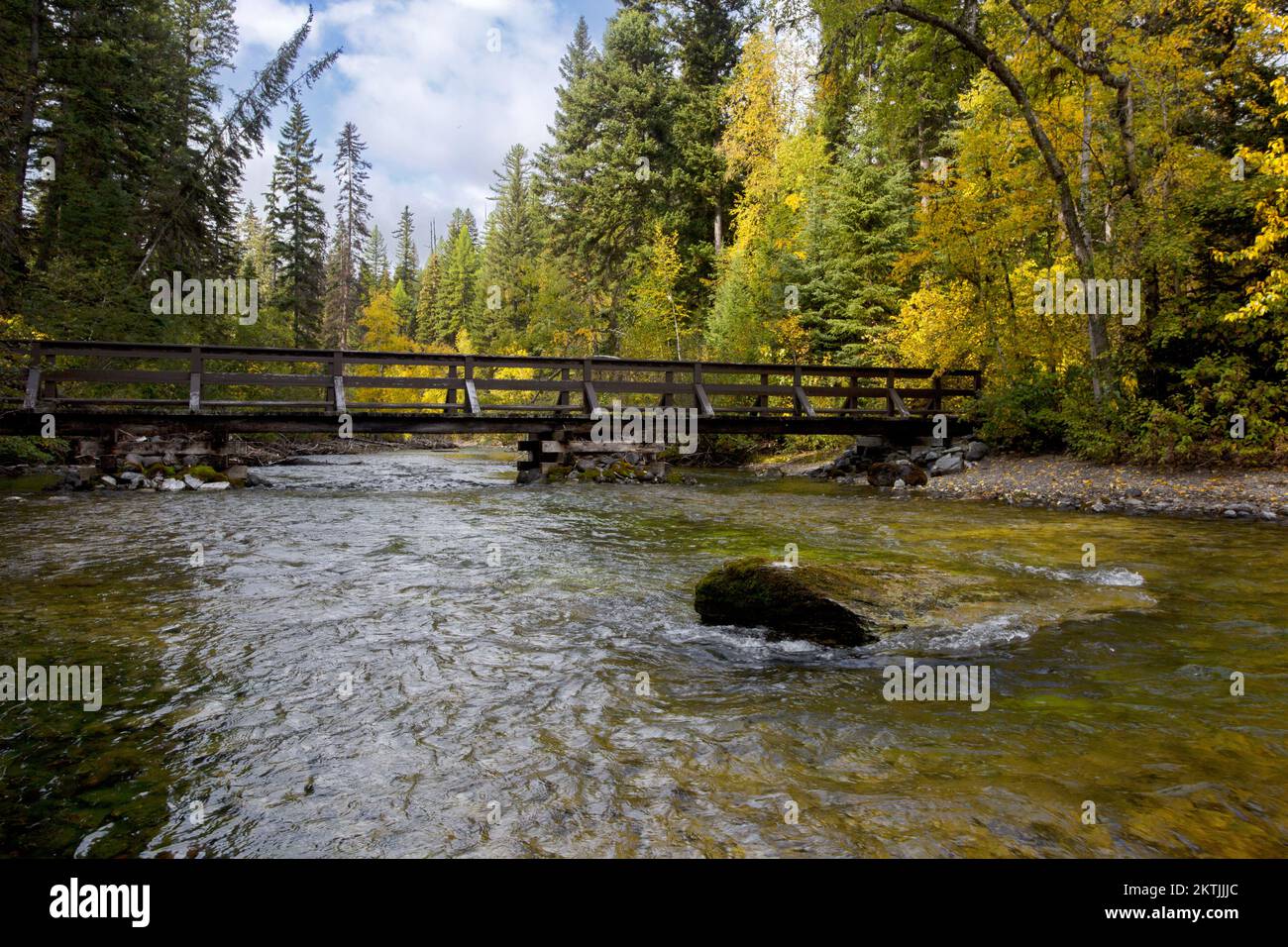 Simple, rustic wood bridge over Kintla Creek in Glacier National Park ...