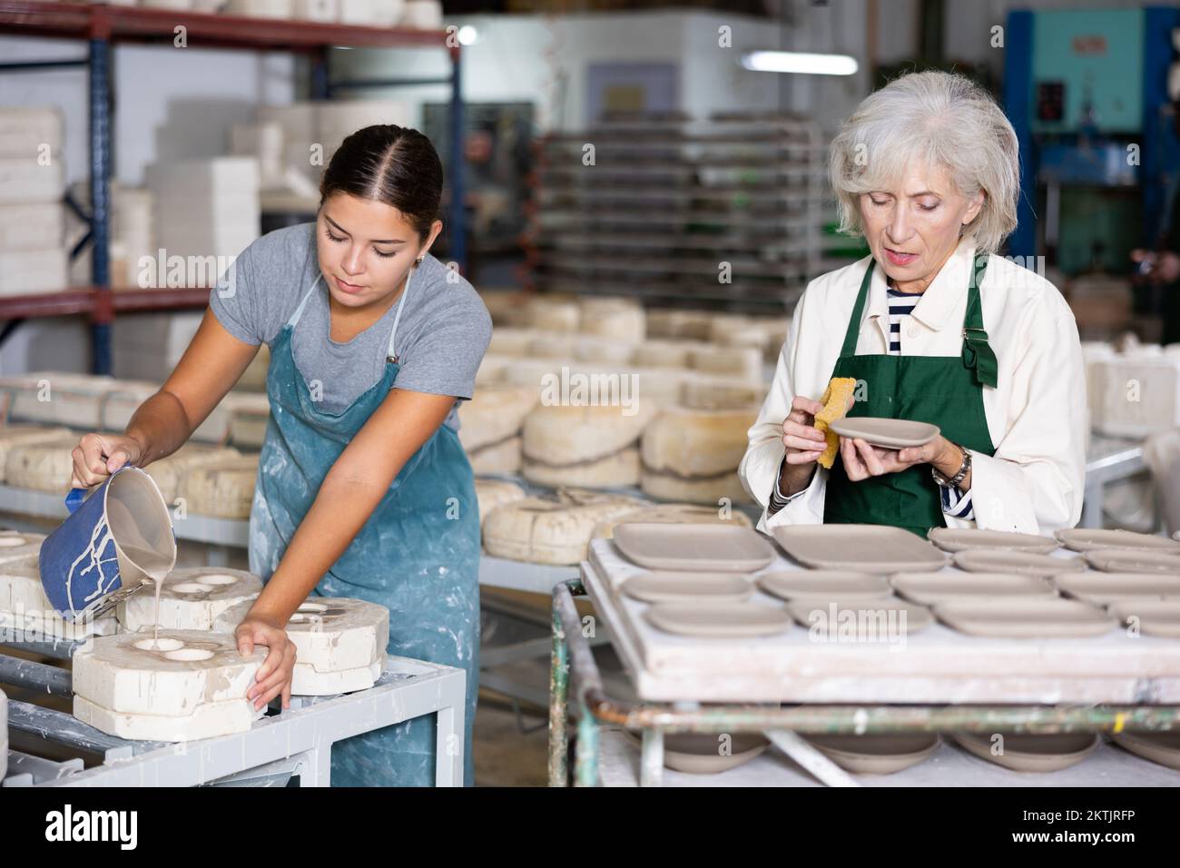 Pouring slip mass into plaster molds at pottery factory Stock Photo - Alamy