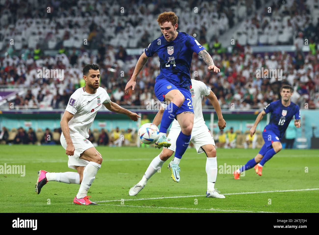 Doha, Qatar. 29th Nov, 2022. Saeid Ezatolahi (L) of IR Iran in action ...