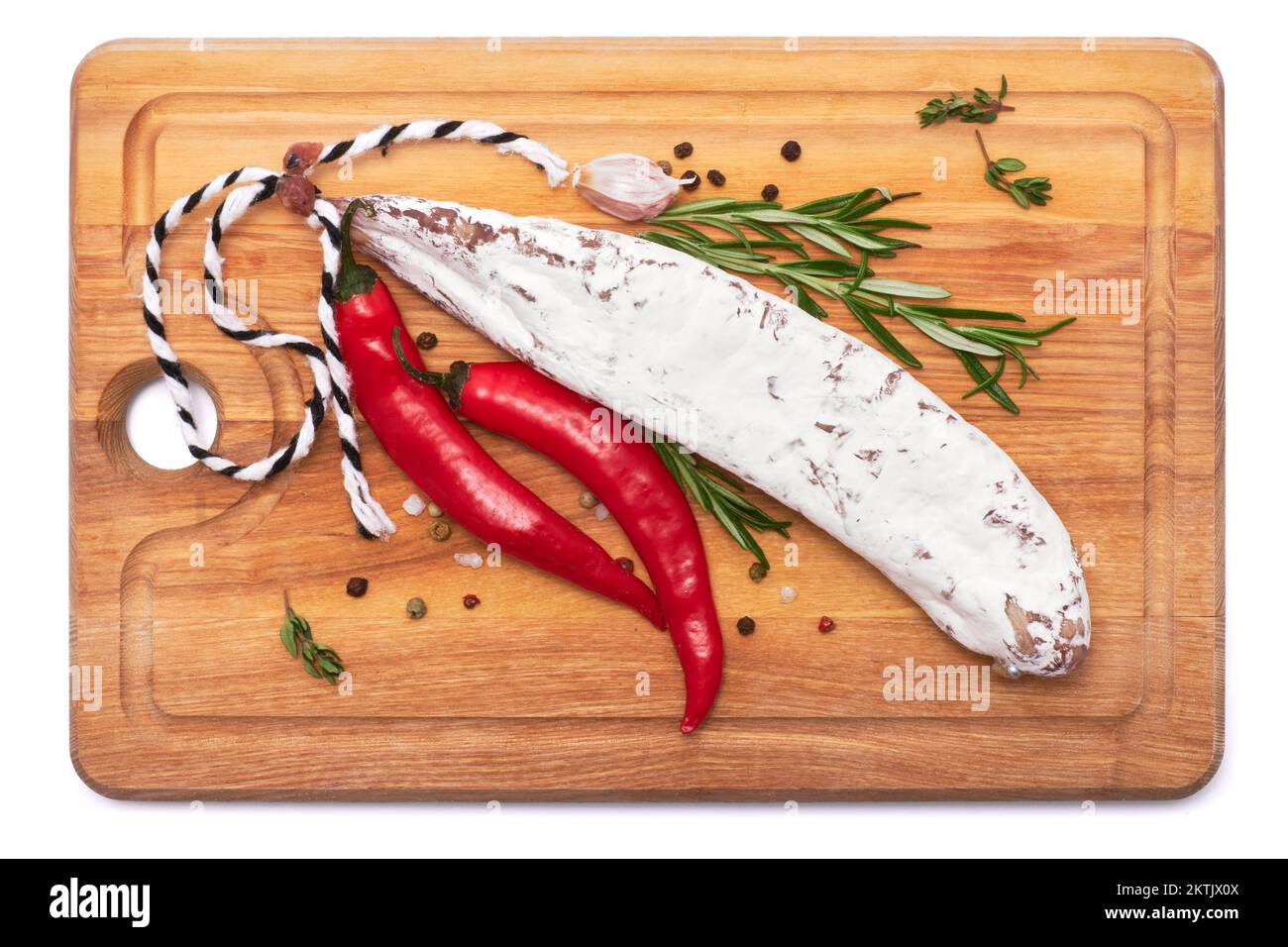 Spanish Fuet thin dried salami sausage on wooden cutting board isolated ...