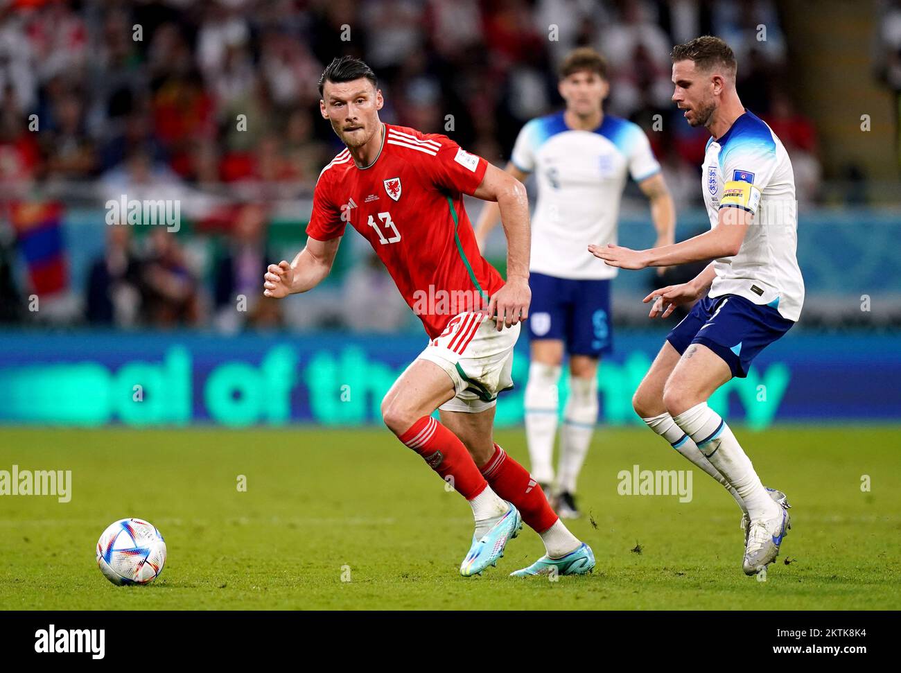 Wales' Kieffer Moore, (left) with England's Jordan Henderson, (right ...