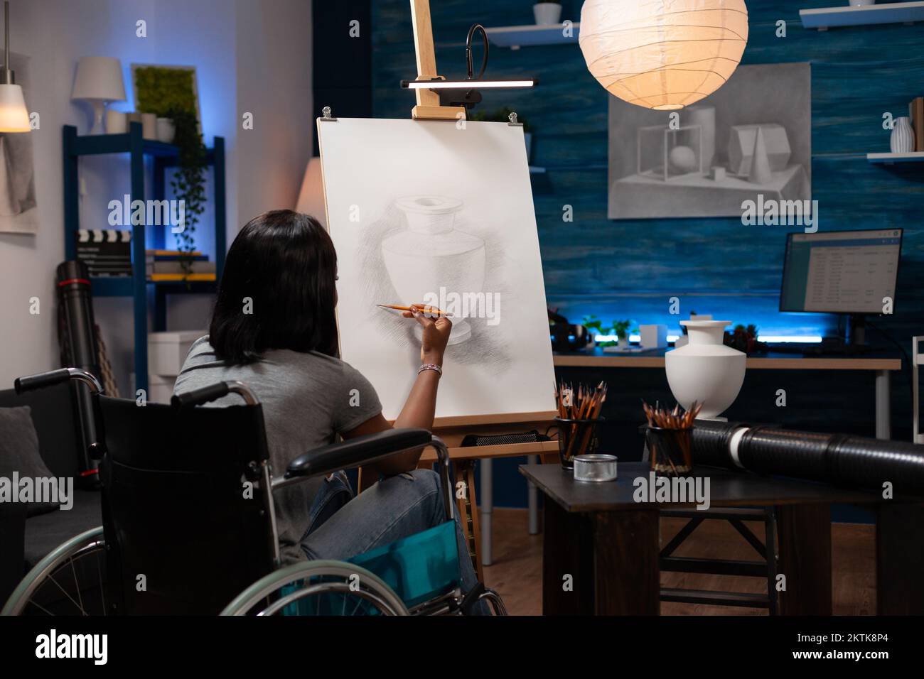 Fine arts teacher who lives with disability in legs putting final ...