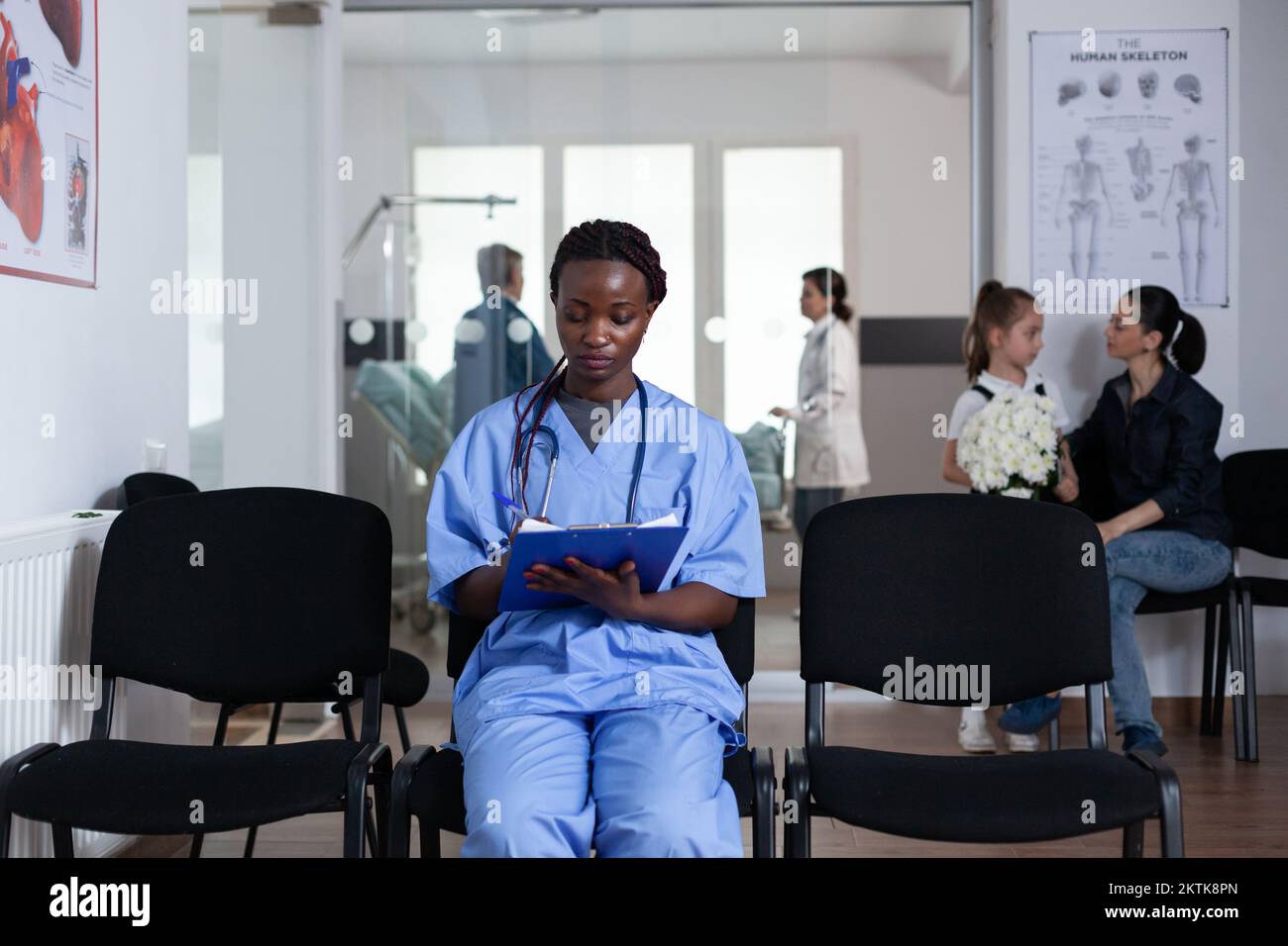 Nurse filling out paperwork for patient hi-res stock photography and ...