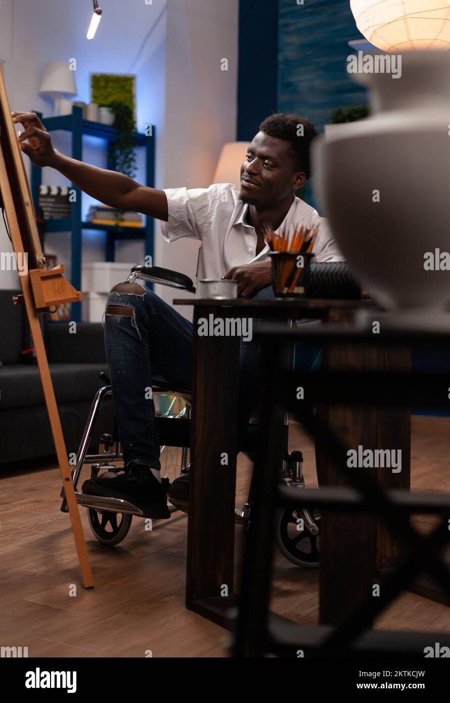 Artist living with disability making vase drawing on canvas. Happy ...