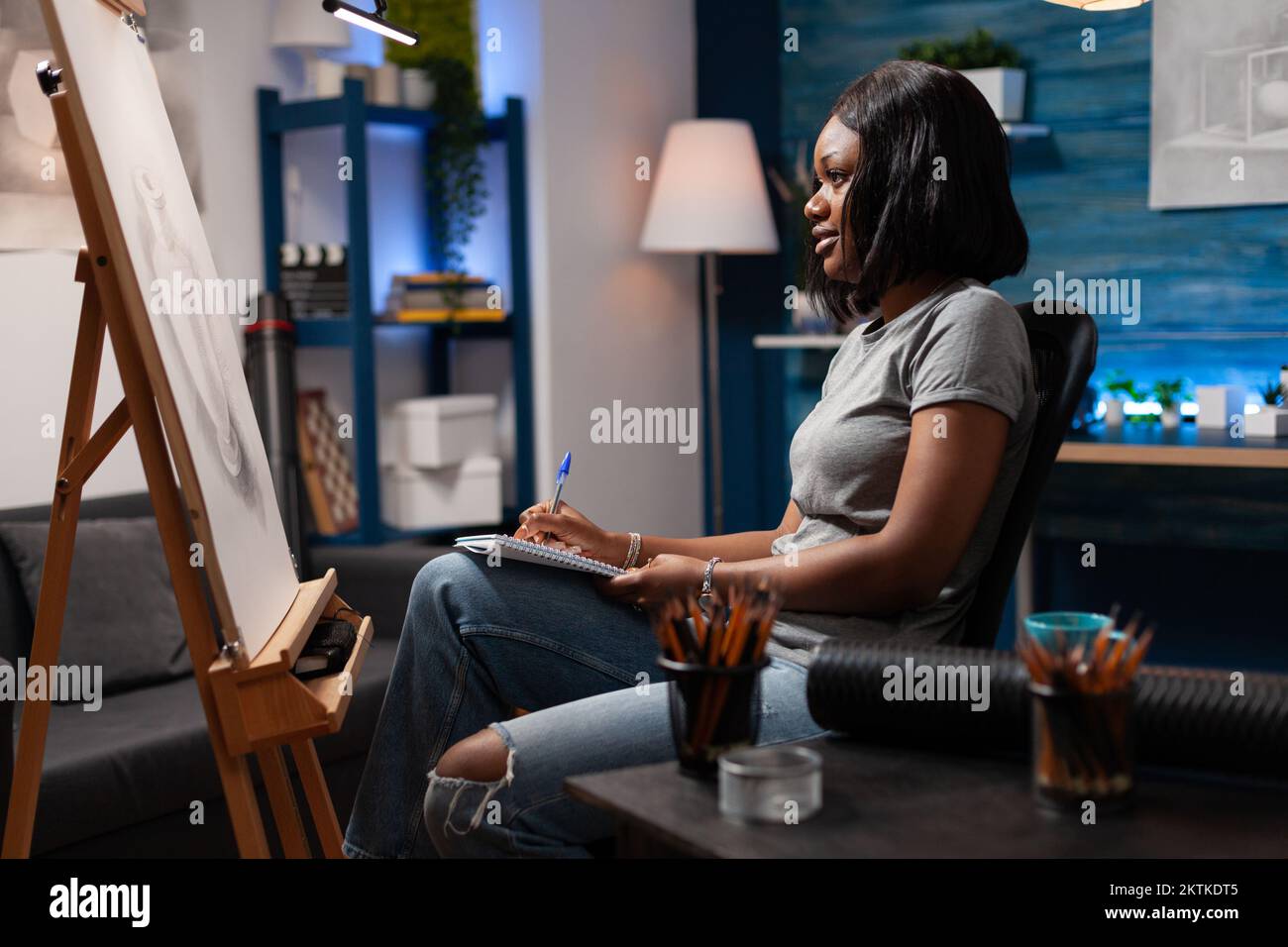 African american woman with artistic abilities appreciating completed ...