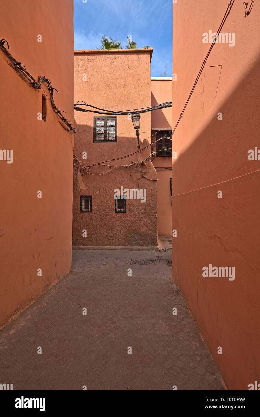 Red colored houses in Marrakesh and an alley Stock Photo - Alamy