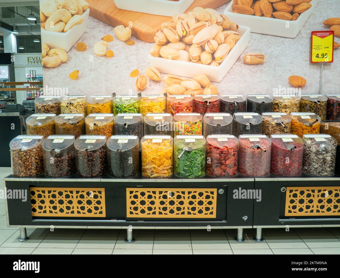 Store shelves. Transparent boxes with nuts in the store. Dried fruits ...