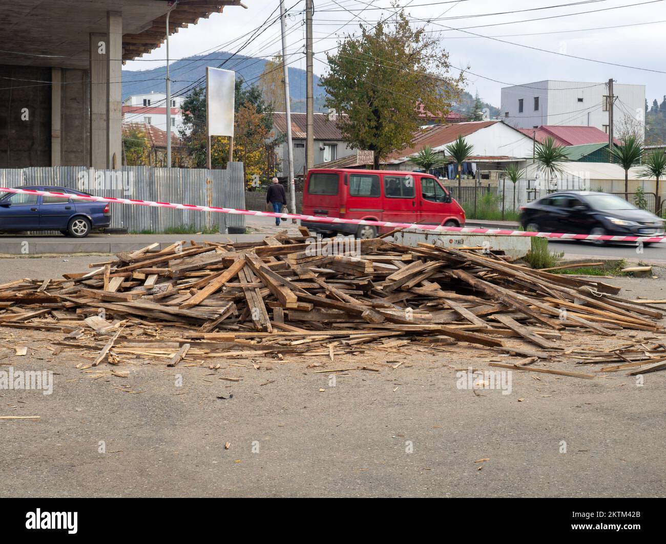A pile of old boards lies on the street. Used building materials ...