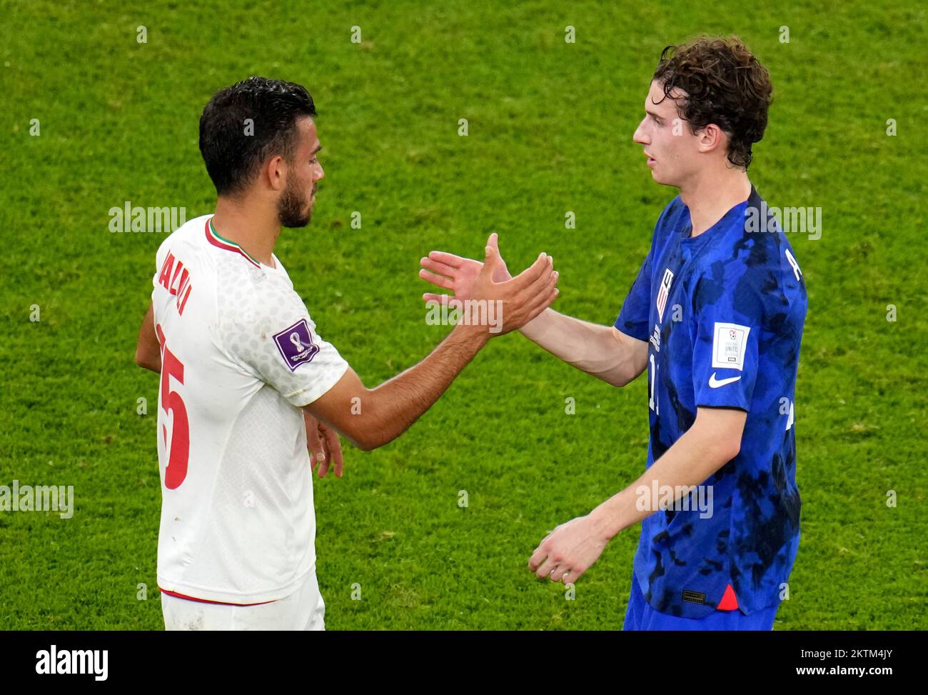 Doha, Qatar. 29th Nov, 2022. Abolfazl Jalali (L) of Iran greets Brenden ...