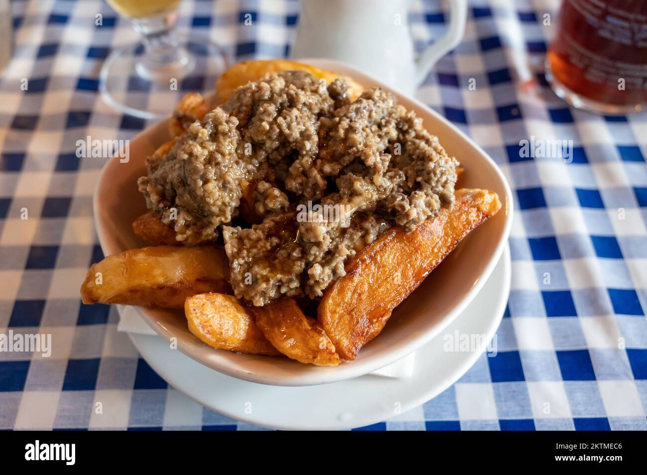 Scottish traditional snack food, hand cut potato chips topped with ...