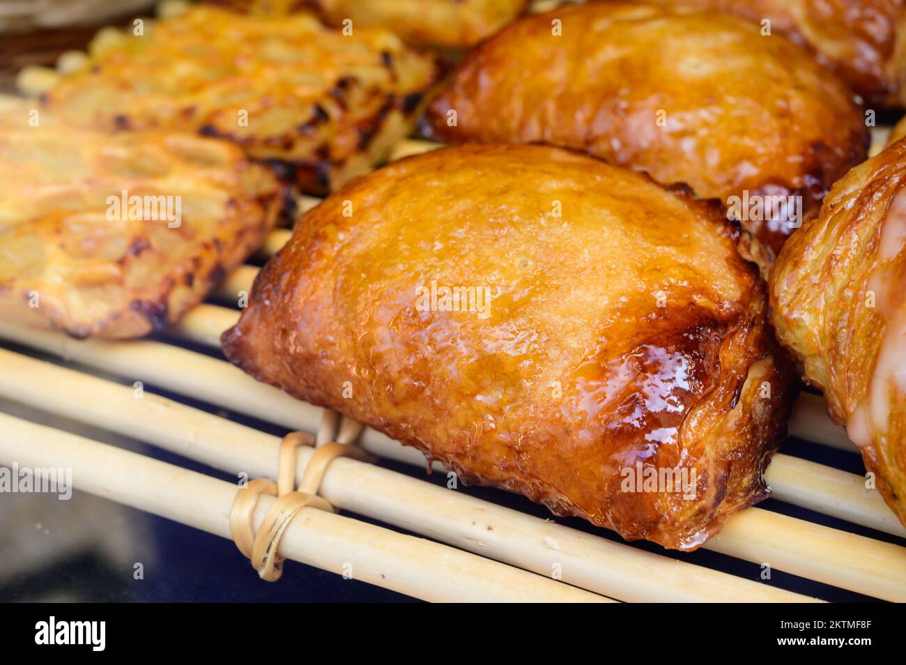 French bakery, fresh baked sweet buns and rolls on display in small ...