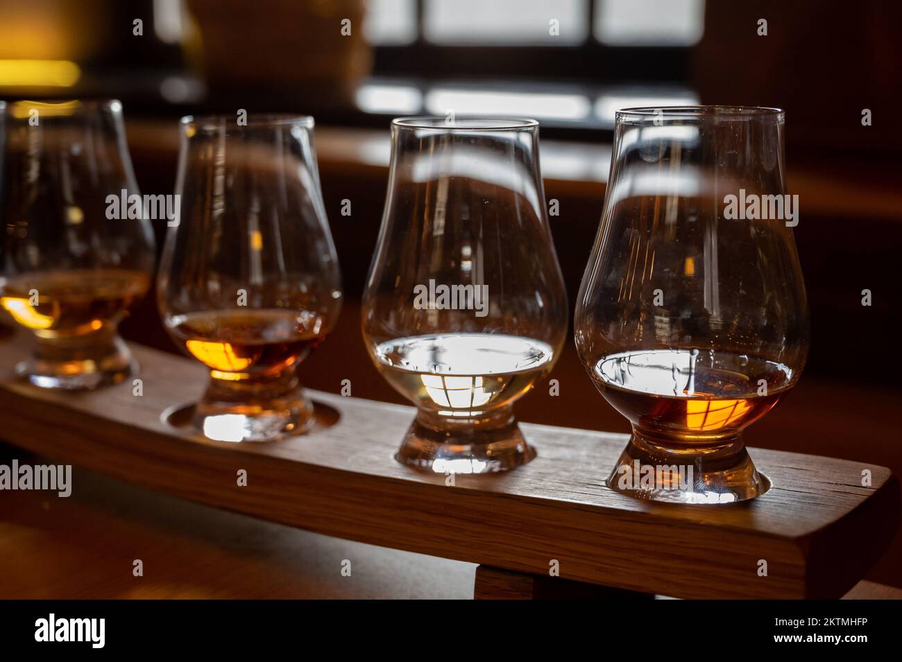 Flight of single malt scotch whisky in glasses served in bar in ...