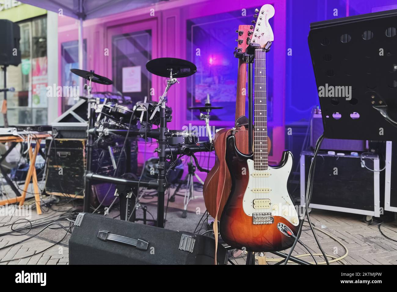 Electric guitar with wires stands on a stage Stock Photo - Alamy