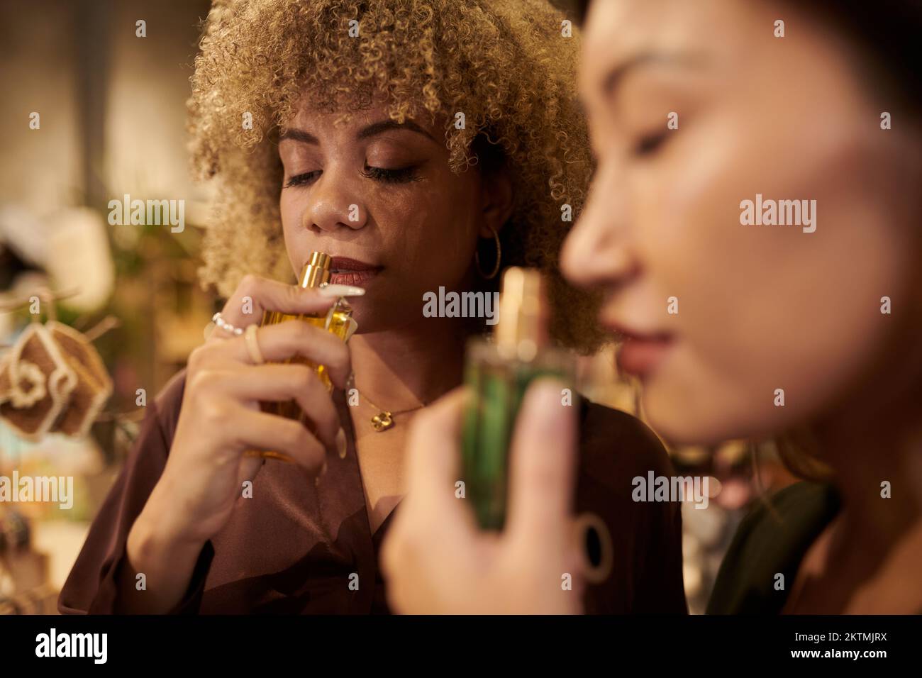 Woman enjoying delicious smell of perfume from new collection Stock ...