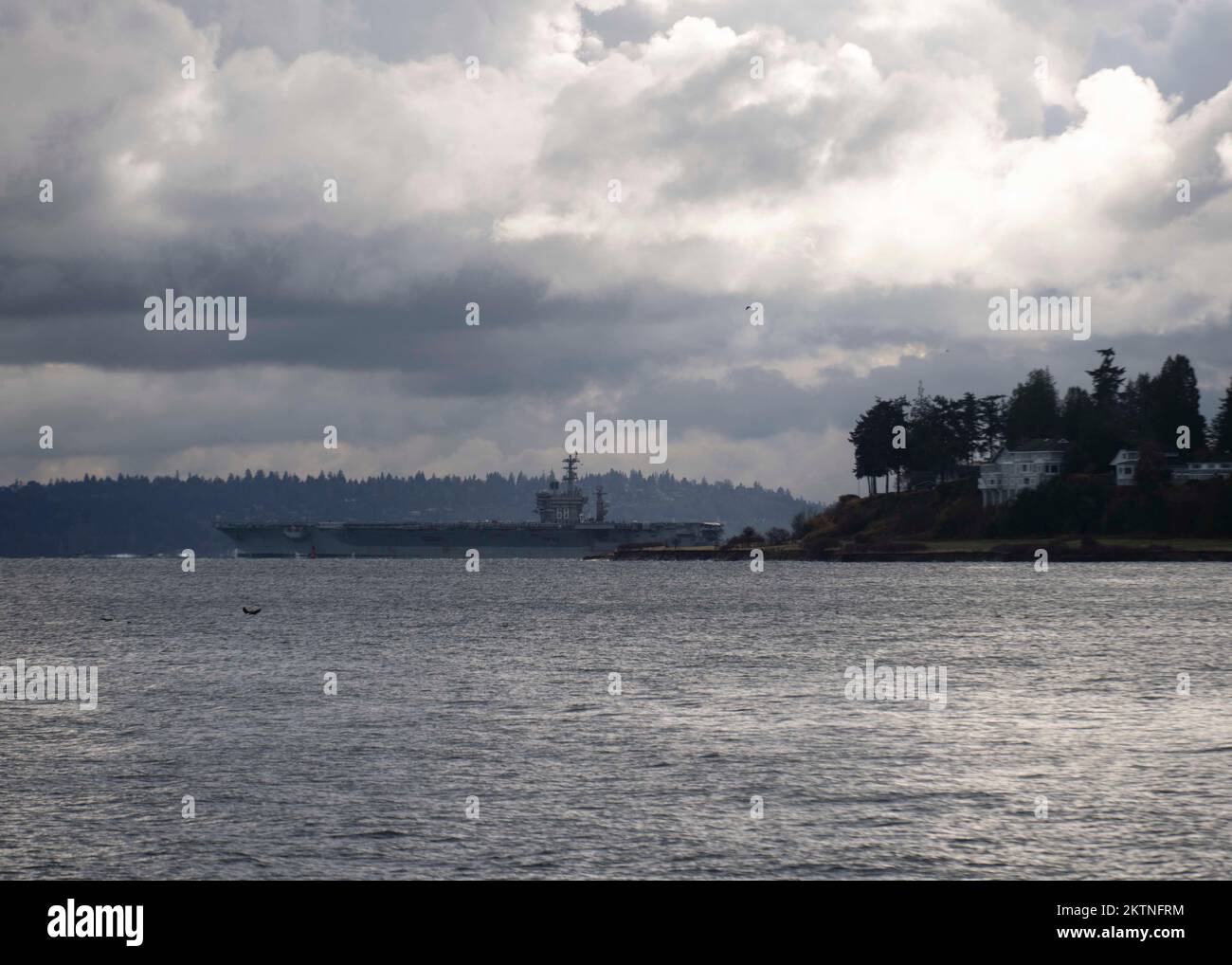 The aircraft carrier USS Nimitz (CVN 68) transits the Puget Sound after ...