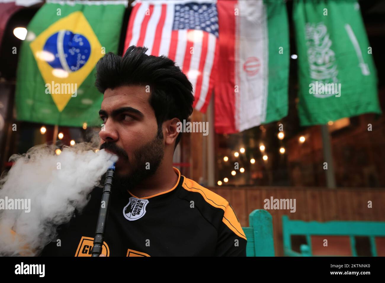Baghdad, Iraq. 29th Nov, 2022. A man smokes shisha as he watches the ...