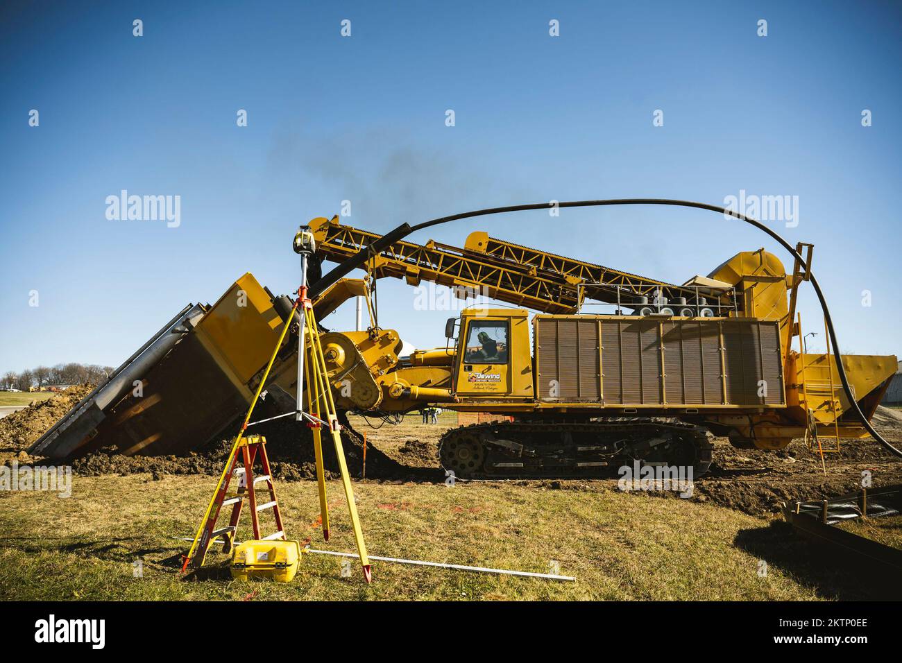 A DeWind construction worker uses the trencher Nov. 21 to dig a 30-foot-deep trench at Wright ...