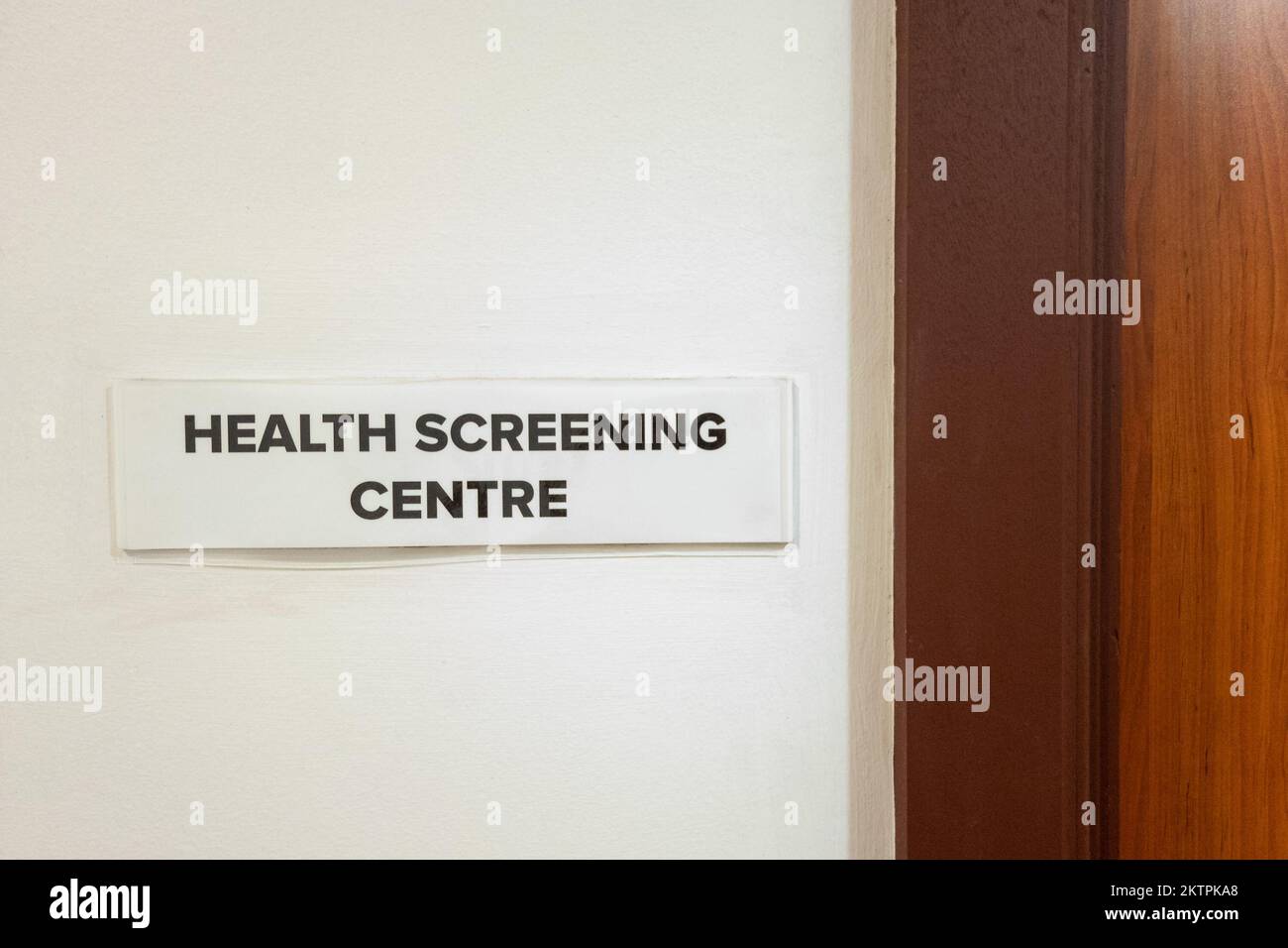 Concept of the word Health Screening Centre at the door entrance of ...