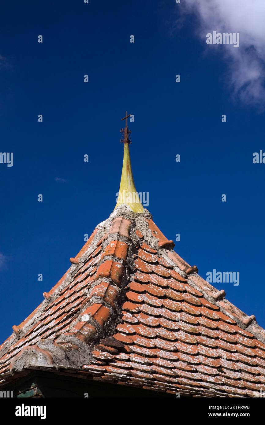 Rooftop with terracotta ceramic tiles and spire with cross, Sighisoara ...
