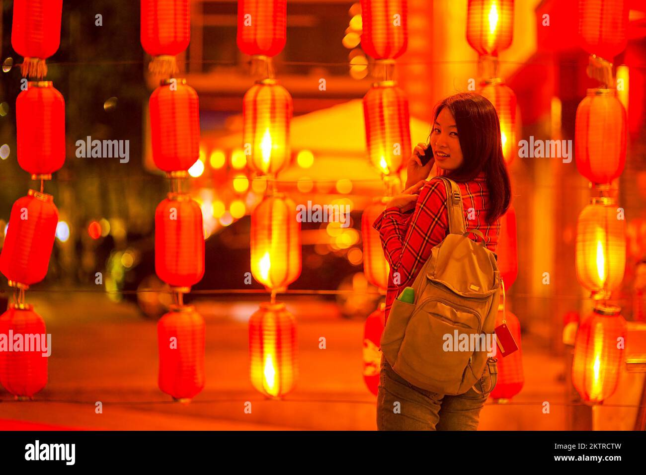 Chinese teenager with cell phone near chinese new year lanterns Stock ...