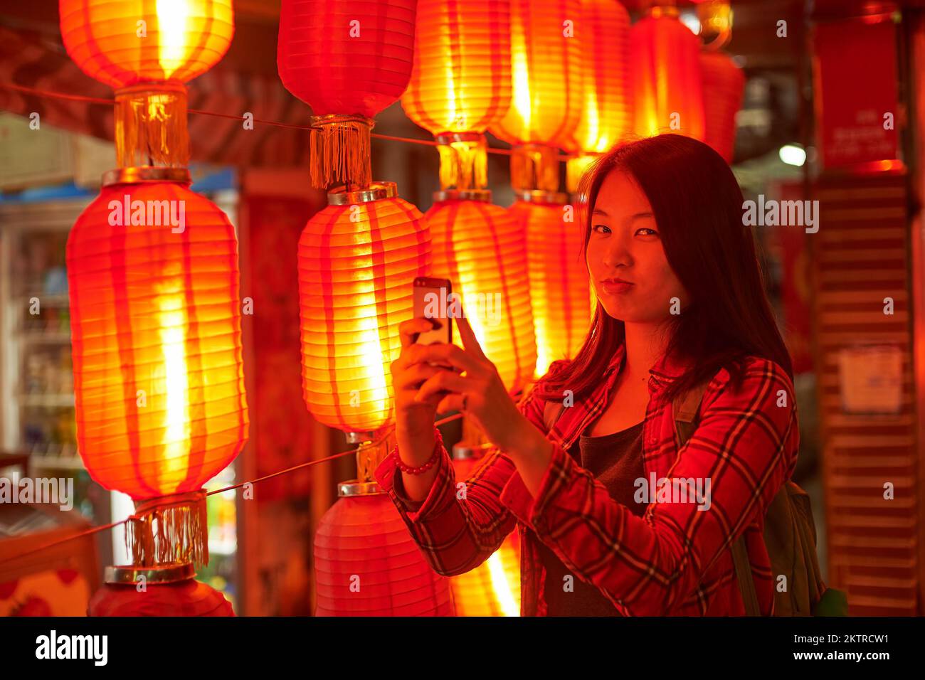 Chinese teenager with cell phone near chinese new year lanterns Stock ...