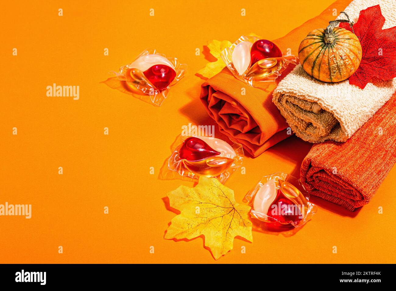 Machine washing concept. Capsules with detergent, soft towels and ...