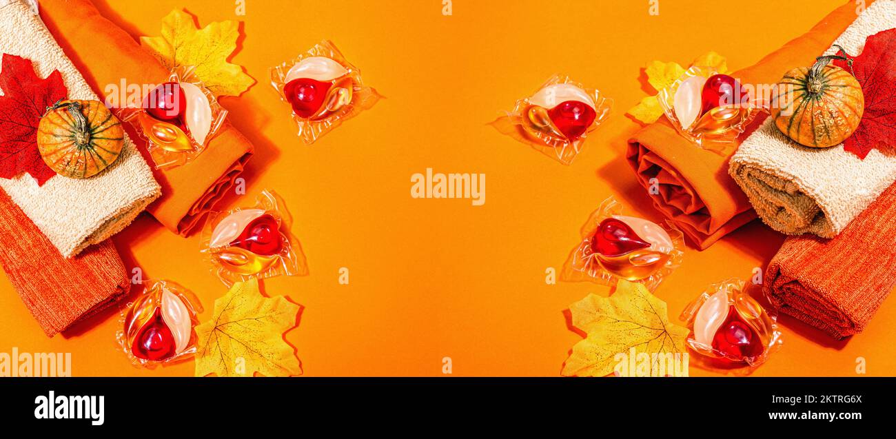 Machine washing concept. Capsules with detergent, soft towels and ...