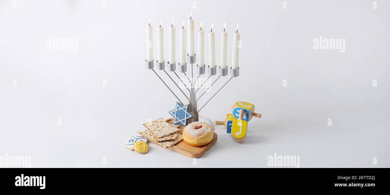 Menorah, dreidels and delicious food for Hanukkah celebration on light ...