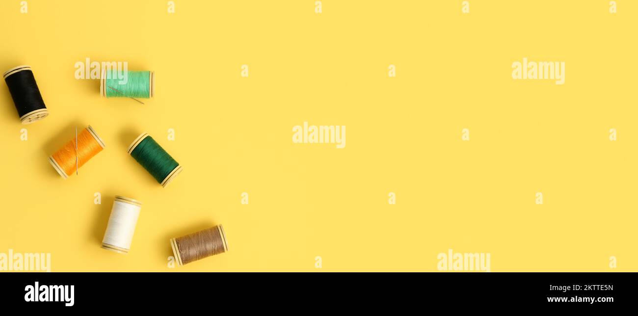 Different thread spools on yellow background with space for text Stock ...
