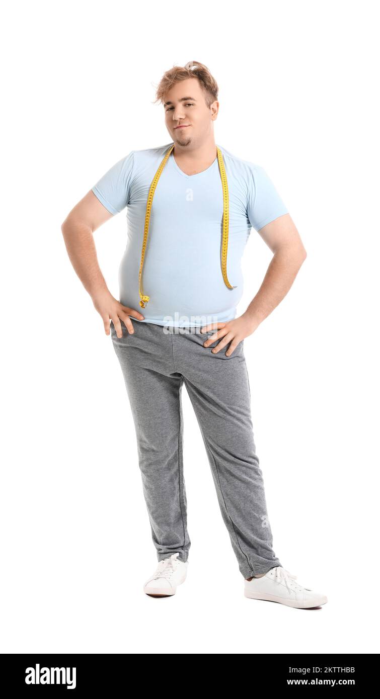 Young overweight man with measuring tape on white background Stock ...
