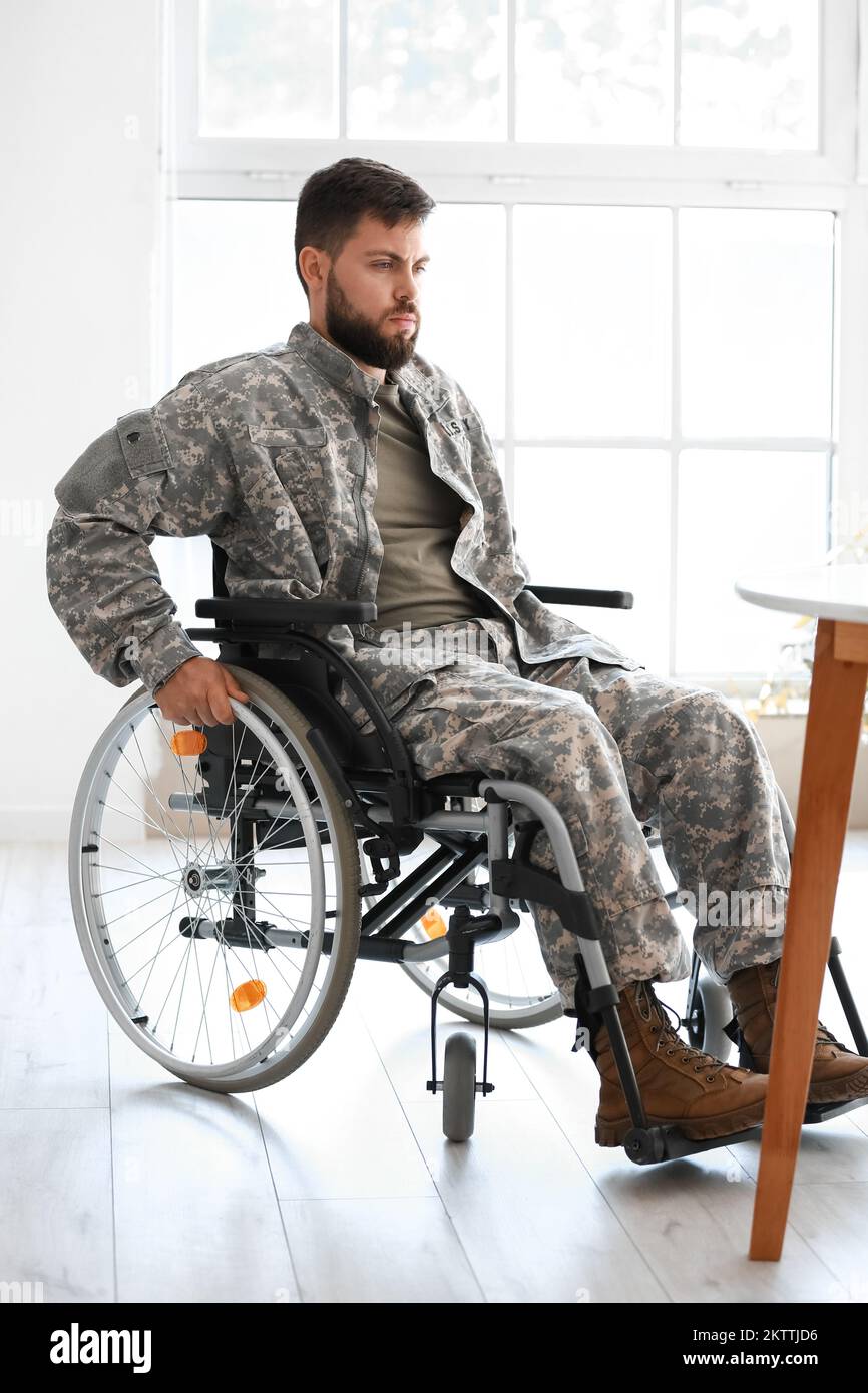 Young soldier in wheelchair at home Stock Photo - Alamy