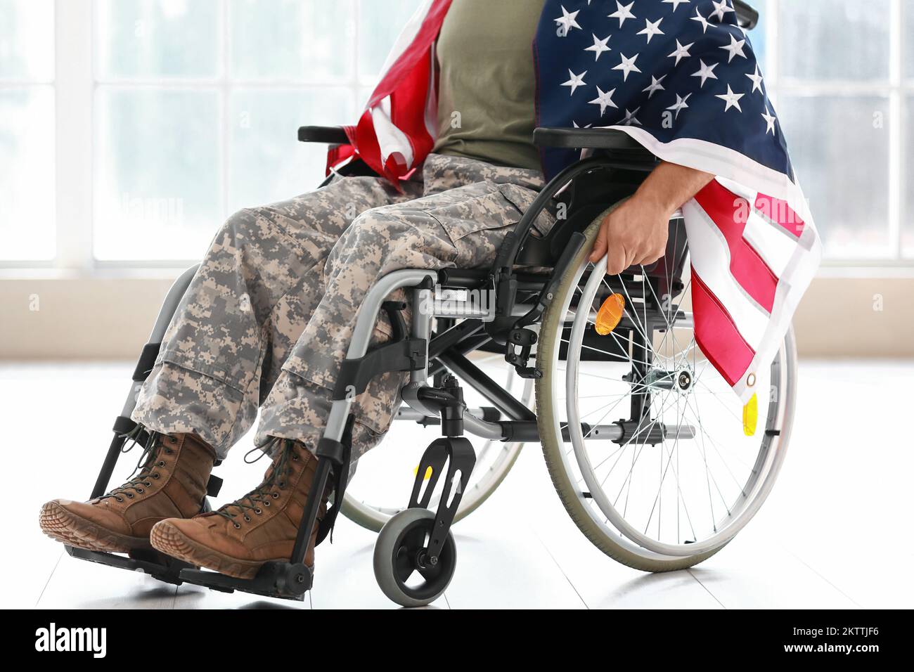 Young soldier in wheelchair with USA flag at home Stock Photo - Alamy