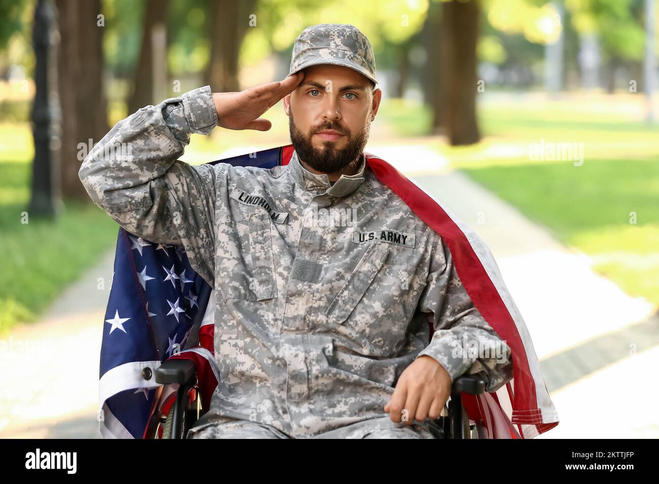 Young soldier in wheelchair with USA flag saluting outdoors Stock Photo ...