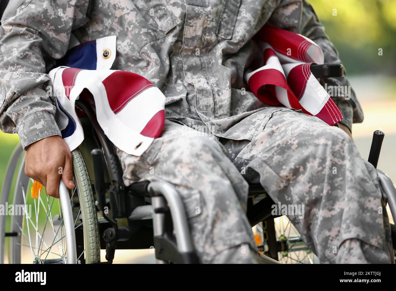 Young soldier in wheelchair with USA flag outdoors, closeup Stock Photo ...