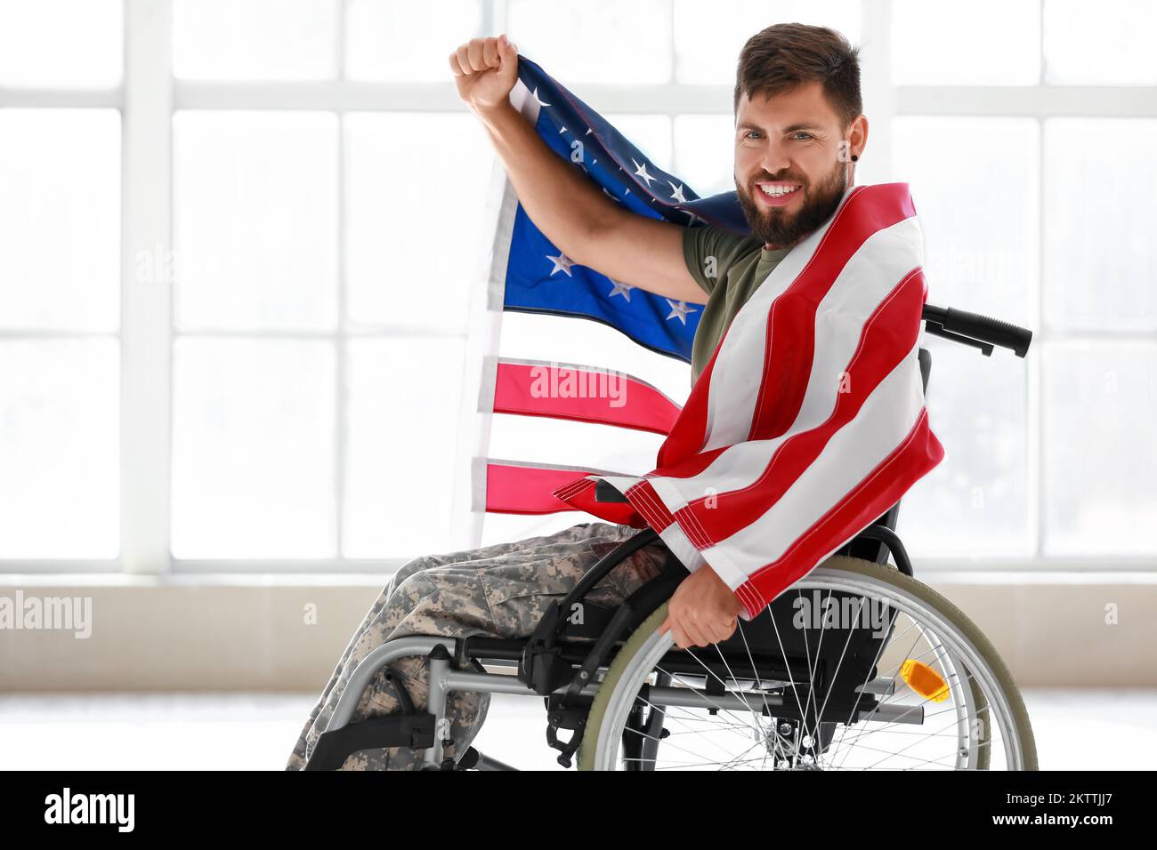 Young soldier in wheelchair with USA flag at home Stock Photo - Alamy