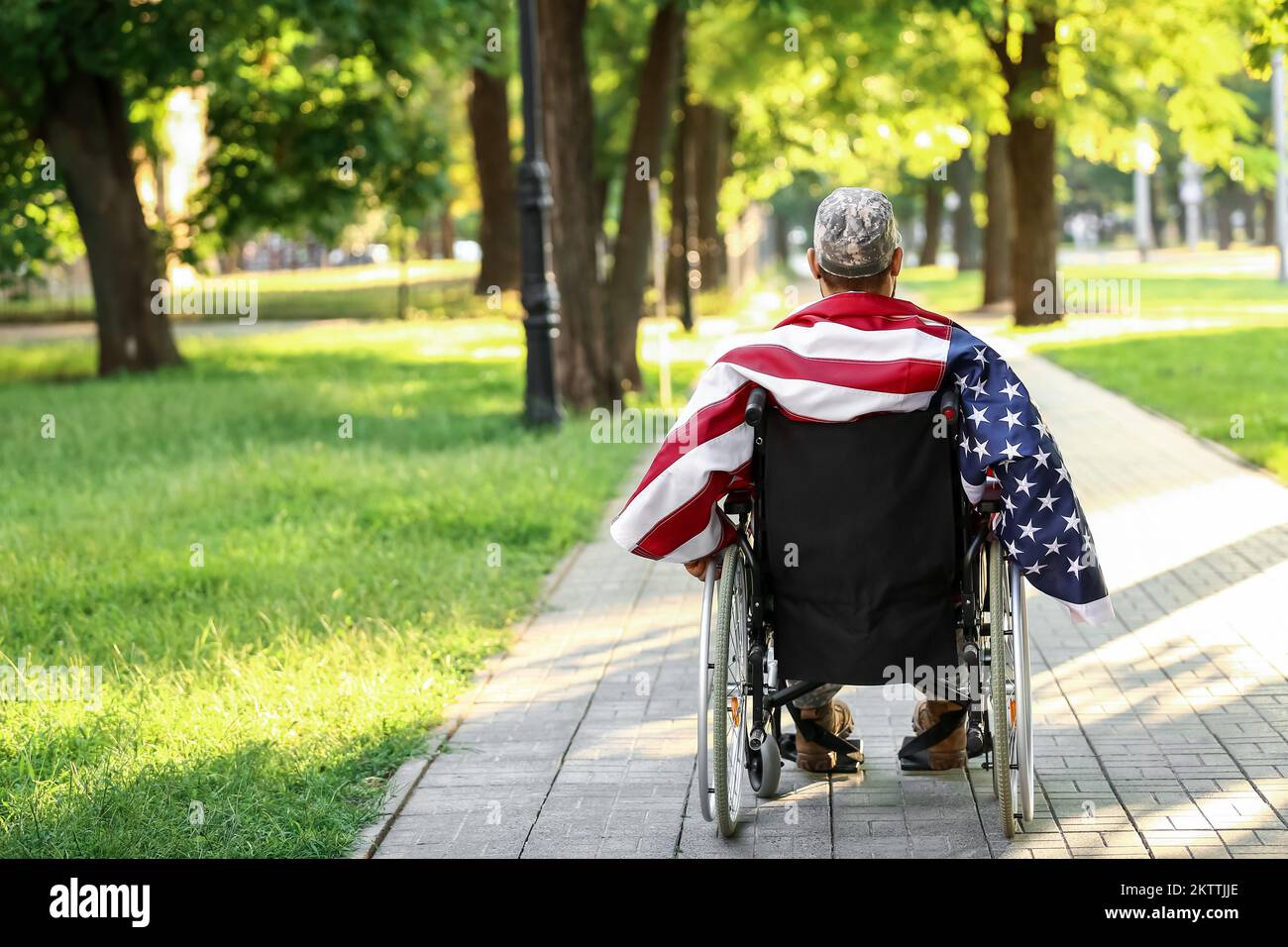 Young soldier in wheelchair with USA flag outdoors, back view Stock ...