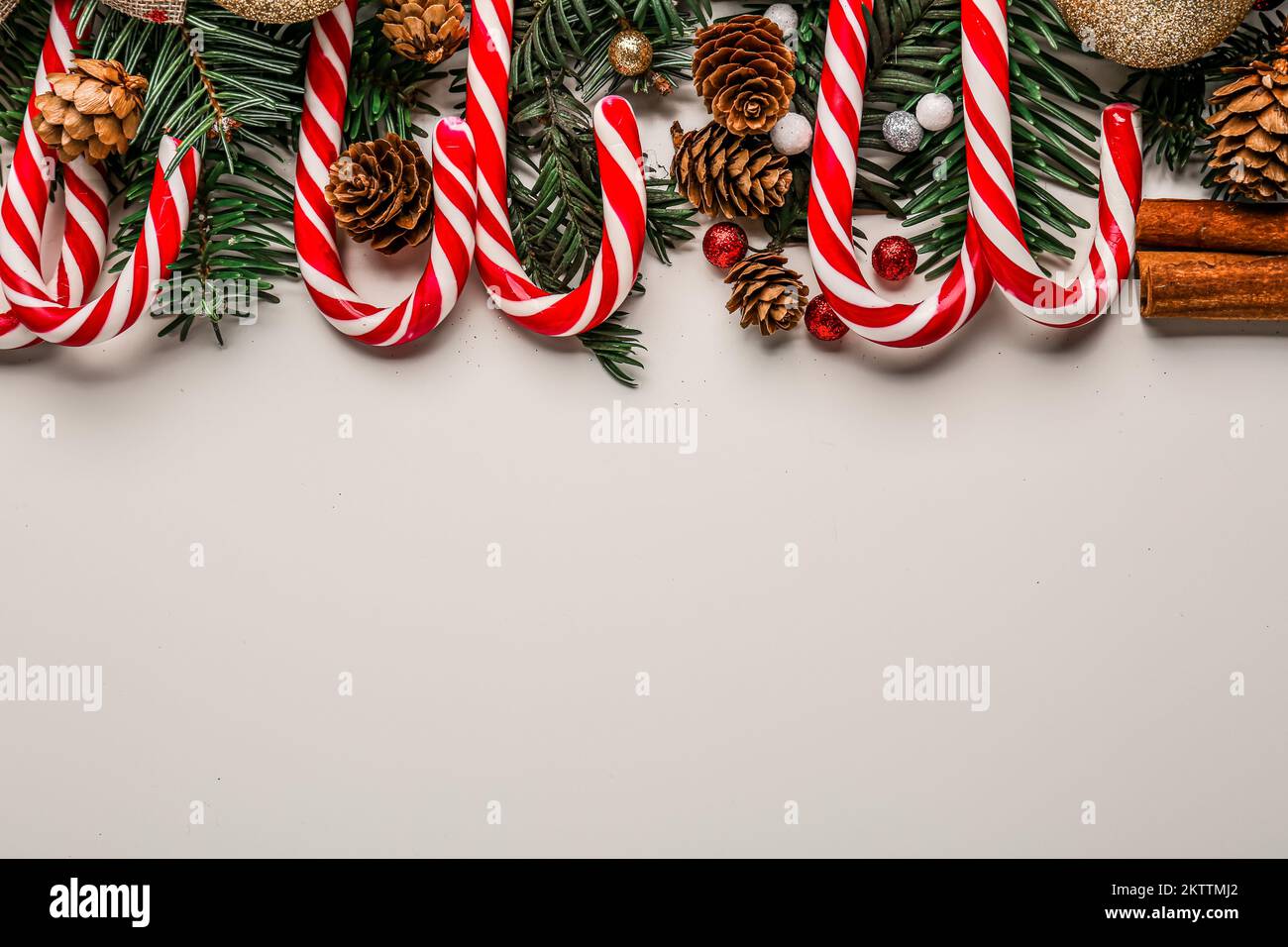 Composition with candy canes, fir branches and Christmas decorations on white background Stock ...