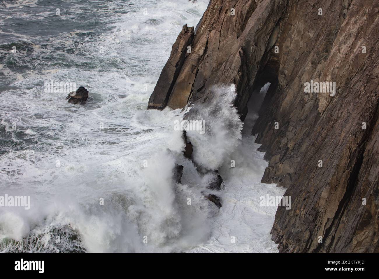 The cold Pacific Ocean crashes against the rugged coastline of northern ...
