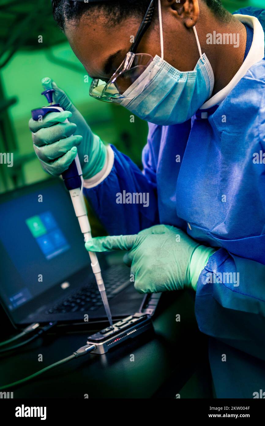Researcher preparing a portable sequencing instrument Stock Photo - Alamy