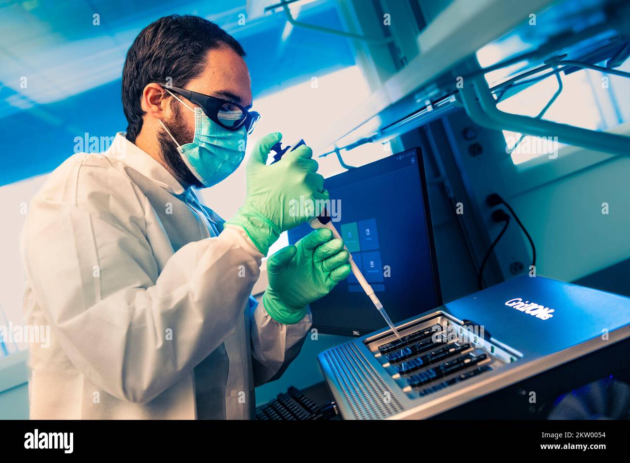 Scientist loading a sequencing instrument Stock Photo - Alamy