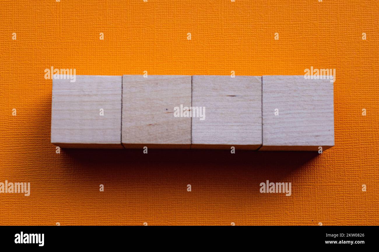 Four wooden cubes on orange background, mockup Stock Photo - Alamy