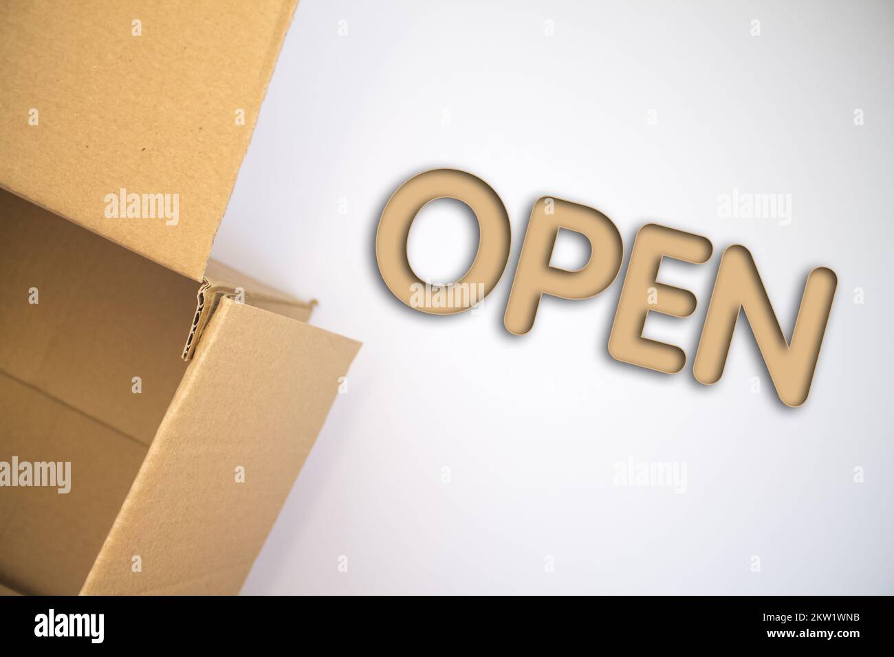 Open word with cardboard box. Brown folded card box Stock Photo - Alamy