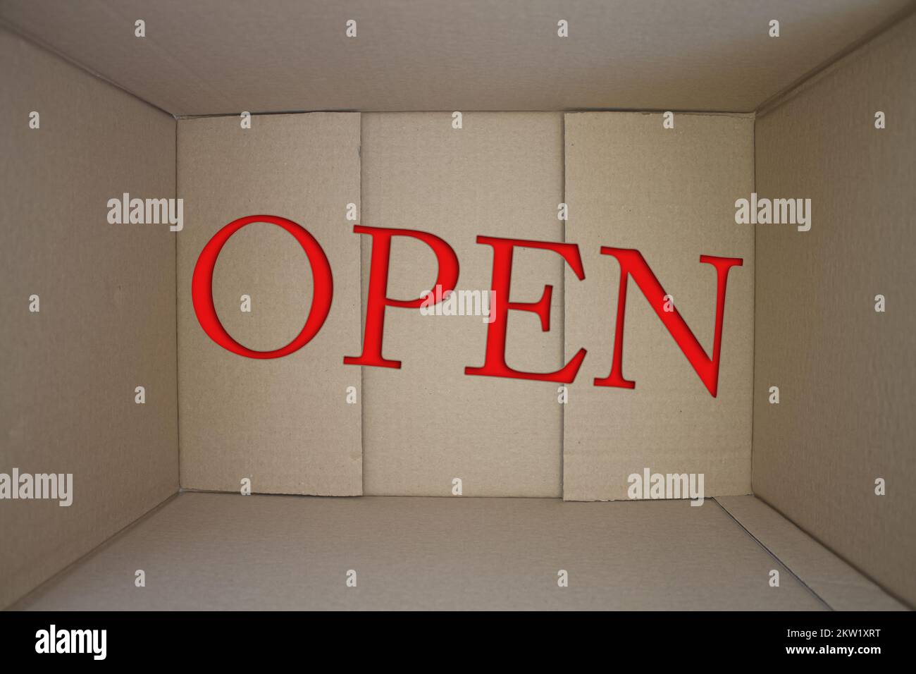 Open word with cardboard box. Brown folded card box Stock Photo - Alamy