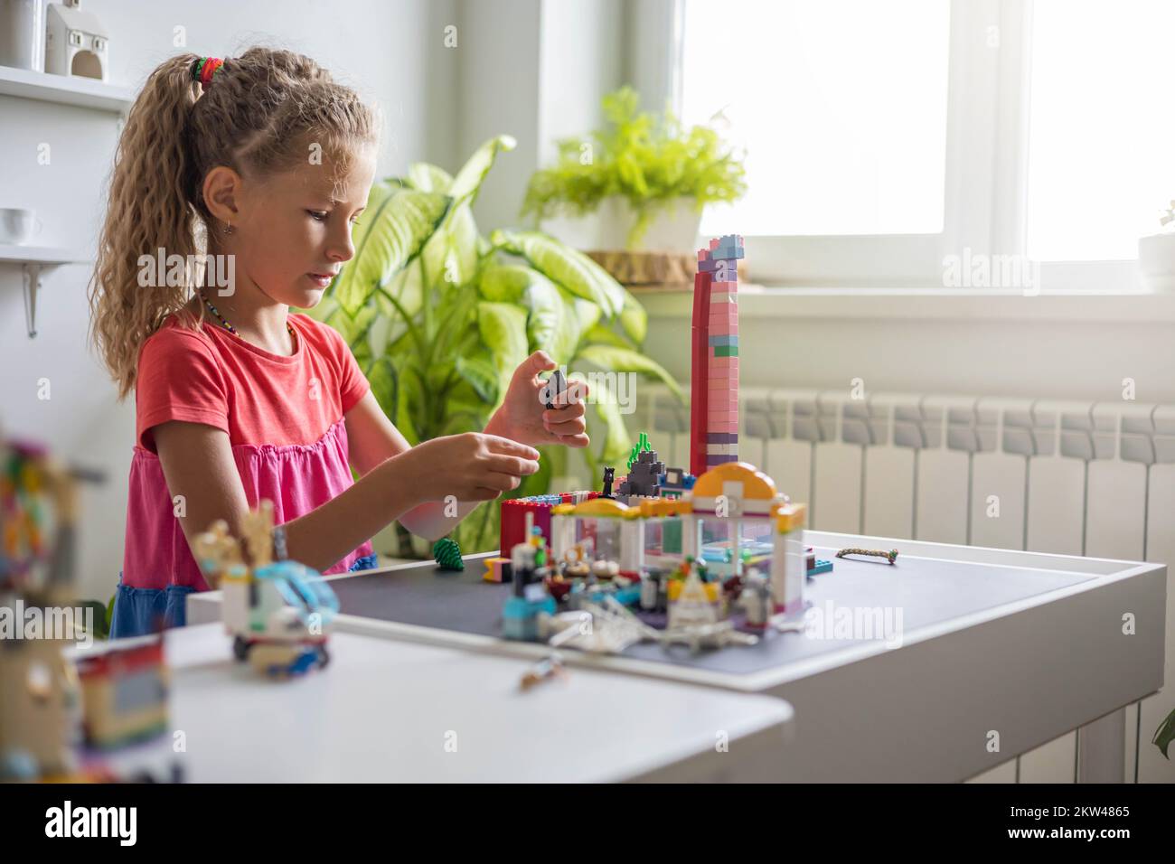 Khabarovsk, Russia, August 25, 2022. Cute girl child constructing toy ...