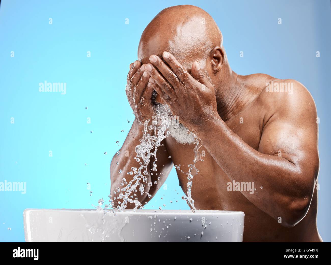 Water splash, face and black man in studio for beauty, skincare and ...