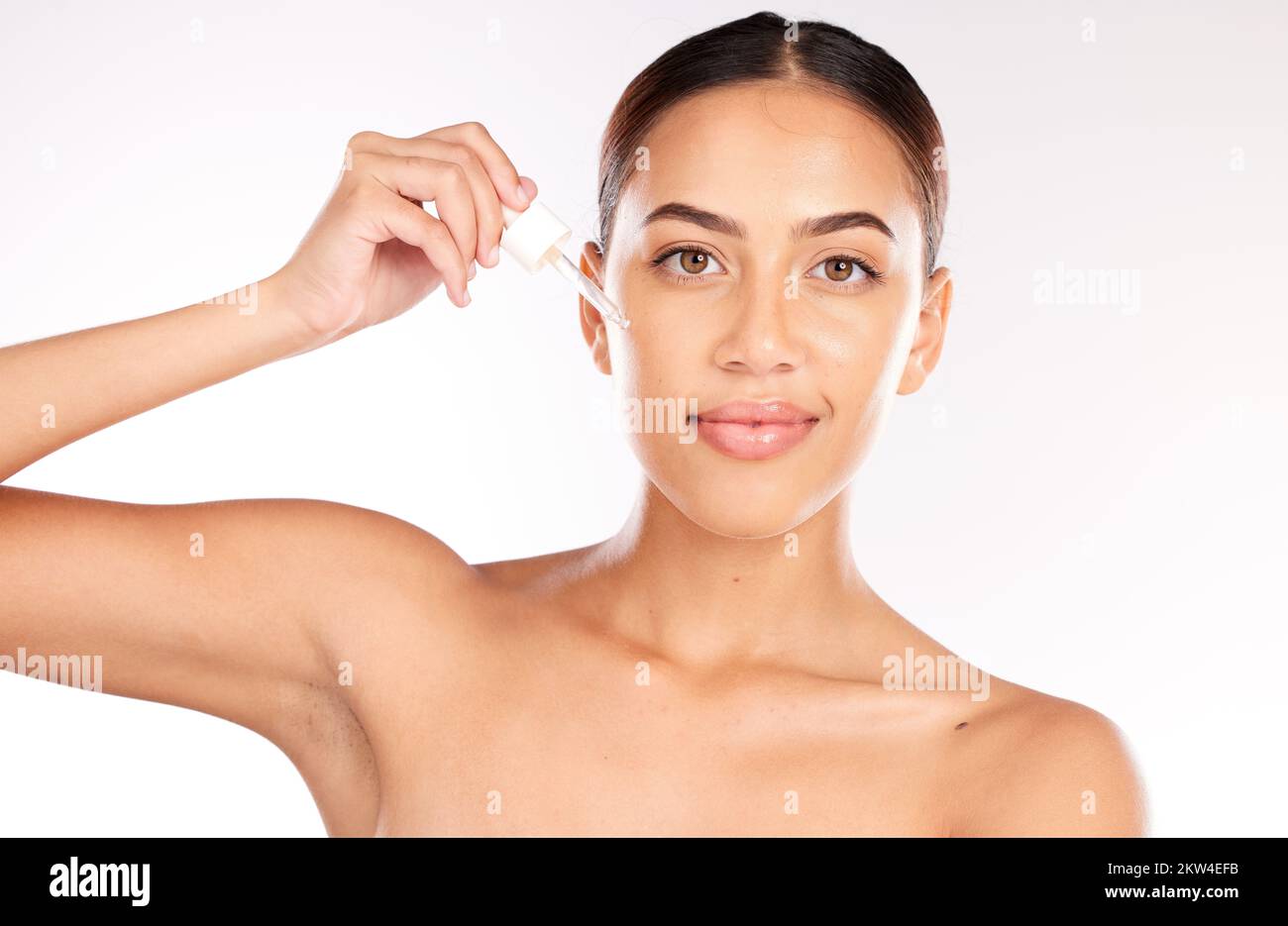 Woman, beauty serum and skincare for face in studio, wellness and ...