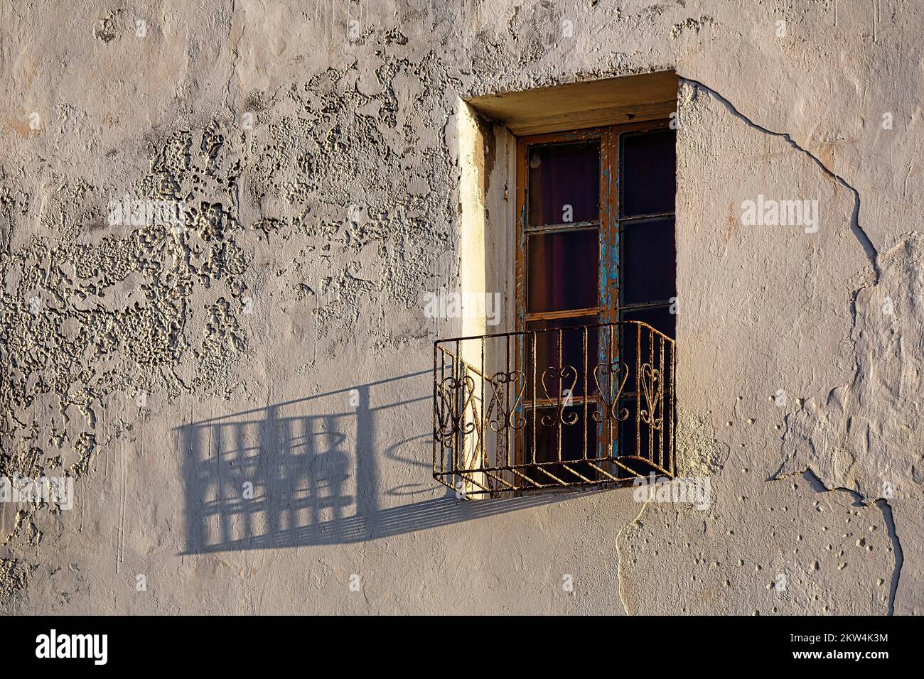 Peeling façade, window with balcony, traditional iron grille casting ...