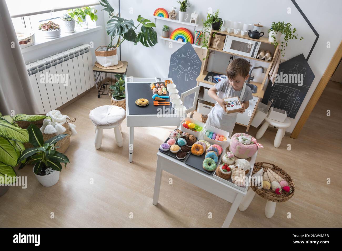 Portrait smiling male kid cafe chef posing with tray full sweet ...