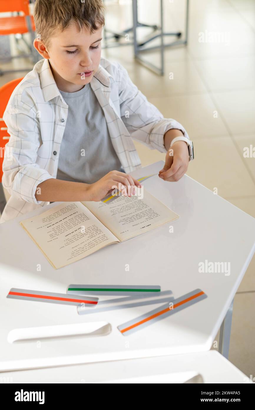 Khabarovsk, Russia, October 28, 2022. Dyslexic child reading book ...